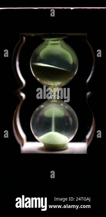Vertical, hourglass. Time lapse, sand in hourglass. Macro, mystical ...