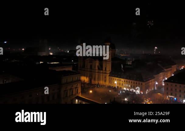 Aerial shot at midnight of fireworks and firecrackers lighting up ...