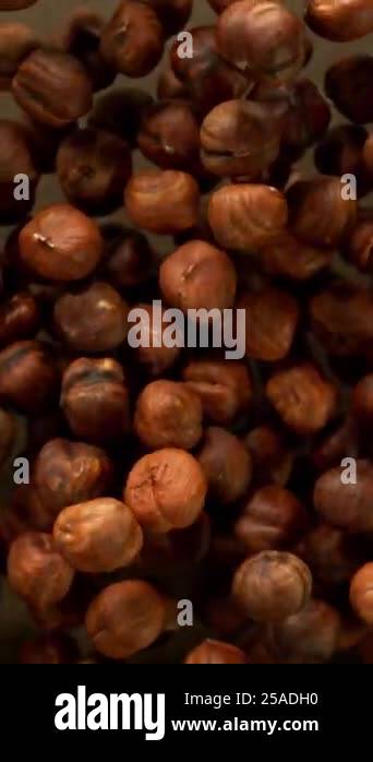 Whole hazelnuts exploding, close-up, wide super macro shot with camera ...