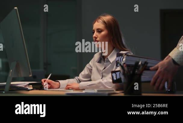 Employee overloaded by paperwork pushes folders out of desk in office ...