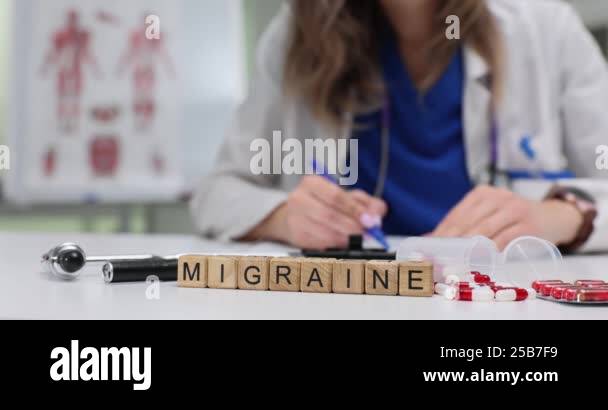 Medical term for Migraine made with wooden cubes and doctor writing at ...