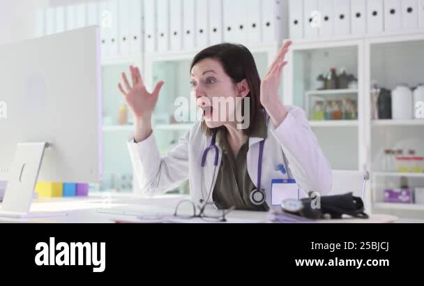 Woman doctor experiences shock looking at computer screen at workplace ...