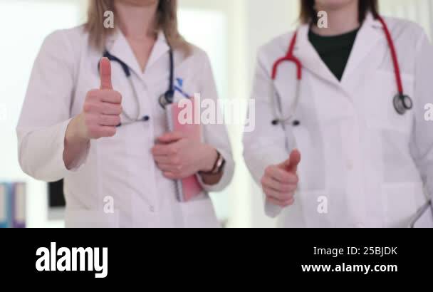 Women doctors hold important documents and show thumbs up. Physicians ...