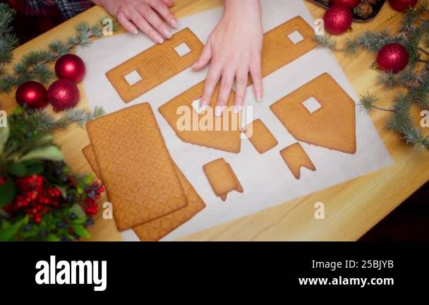A step-by-step process of assembling a gingerbread house with dynamic ...