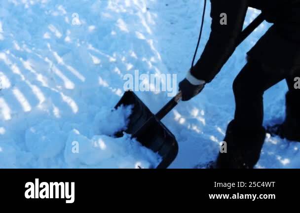 Winter season shows woman shoveling snow in slow motion, clearing ...