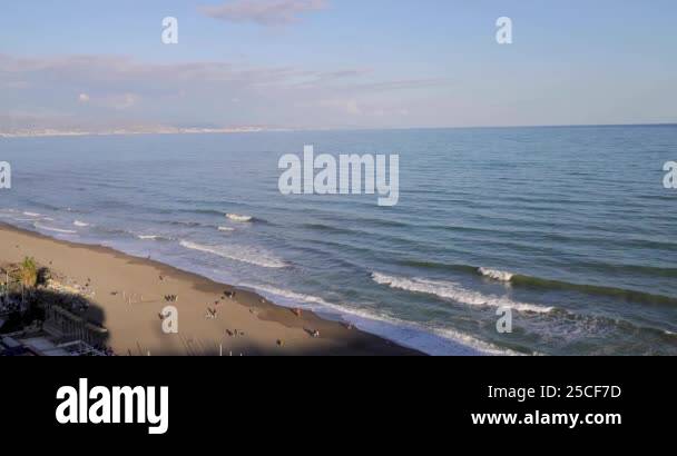 Slow motion panning aerial footage of the beach front in the Spanish ...