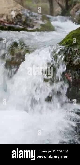Purest transparent water in a mountain river flowing among the stones ...