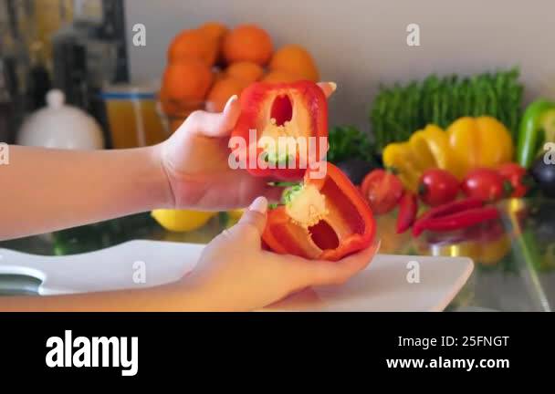 Womens hands hold and twist in different directions a large red bell ...