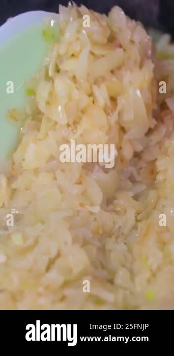 The chef peeling the garlic, The chef stirs the minced garlic with ...