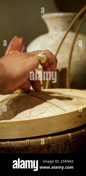 choosing cooked rice in a buffet a mans hand lifts the lids of wicker ...