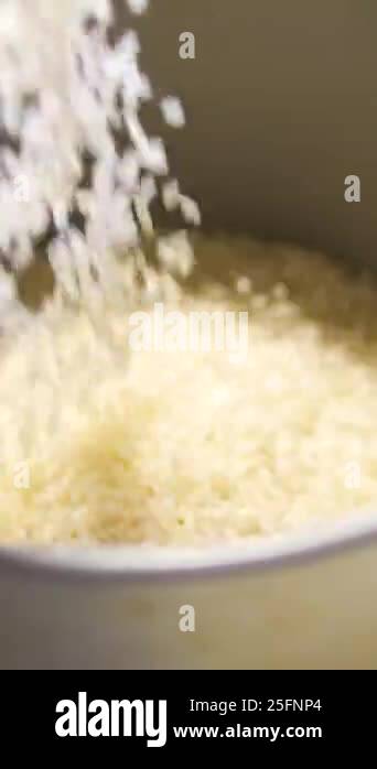 Pouring Rice Grain to Rice Cooker Pot, with Measurement Cup in the ...