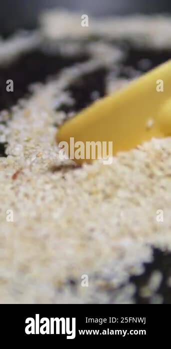 White sesame in the process of roasting to make into snack. High ...