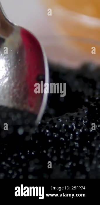 Black caviar close-up. Beluga sturgeon salted roe in glass bowl. Raw ...