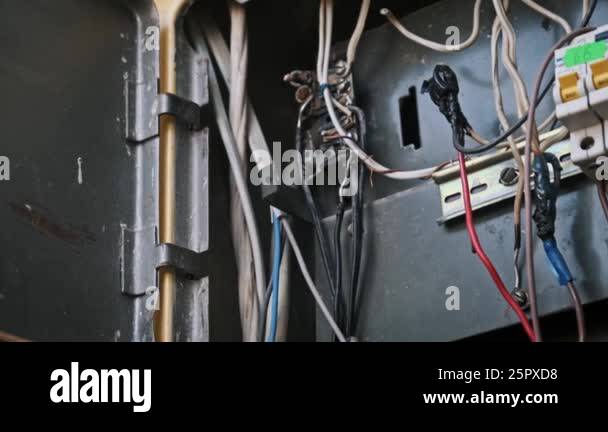 A close view of an electrical box revealing burnt electrical wire ...