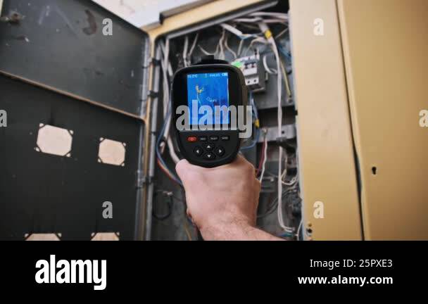 Close view of thermal camera scanning temperature patterns of wires in ...