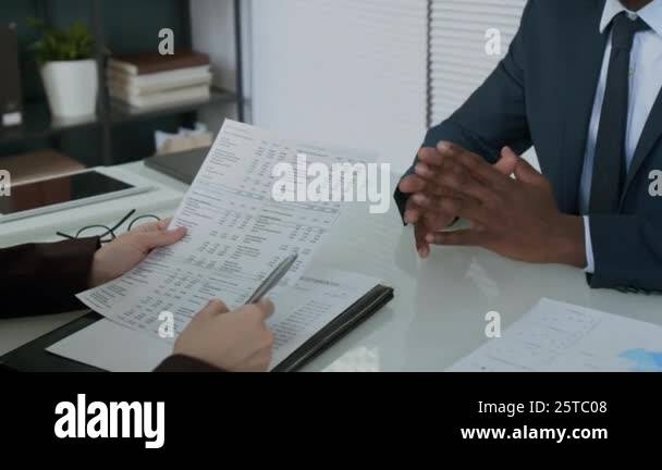 Close up view of unrecognizable woman holding document and taking notes ...