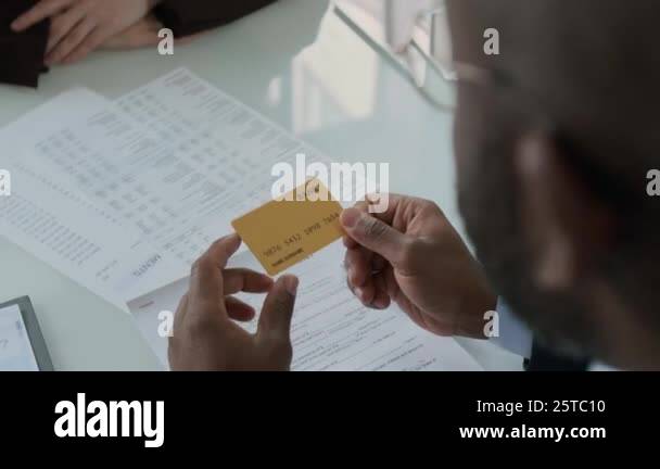 Close-up shot of financial consultant handing over credit card to ...