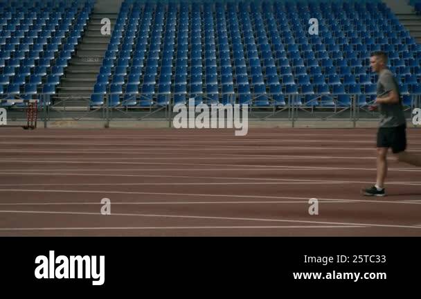 Wide lockdown shot of young male para-athlete with limb difference ...