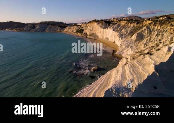 Experience the beauty of Sicily stunning coastline as the sun sets ...
