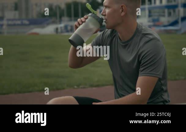 Medium tilting shot of tired, pensive young Caucasian male para-athlete ...