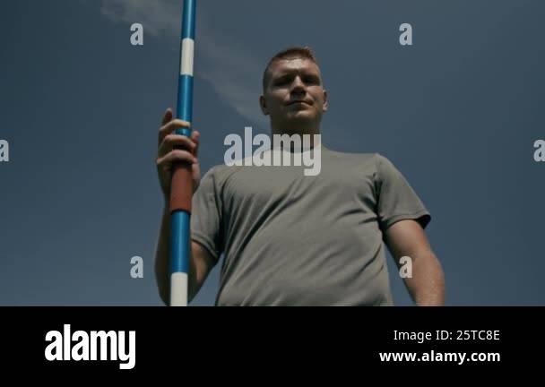 Medium low angle shot of cheerful, determined young Caucasian sportsman ...