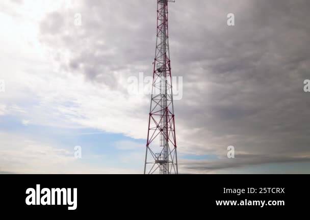 Tall telecommunications tower transmits radio waves. Construction interacts with cellular and ...