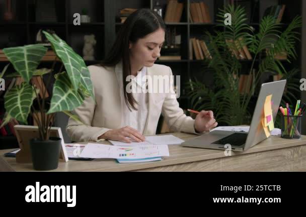 Student intern in classic suit sitting at an office table. Woman ...