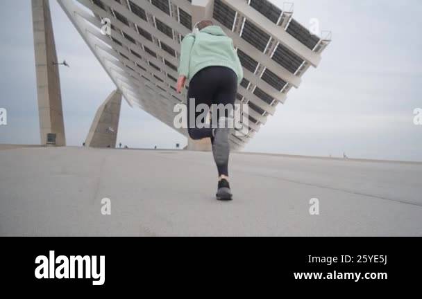 Rear View of an Energetic Woman Running Fast in a Sporty Environment ...