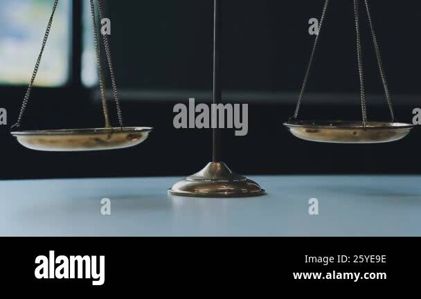 two gold silver scales of justice with the black and white color on a ...