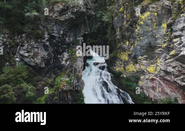 Majestic waterfall cascading through a breathtaking mountain pass Stock ...