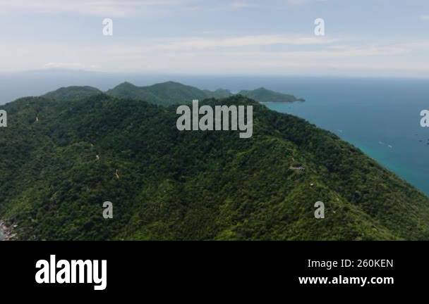 A wide view of lush green hill ranges extending towards the vast blue ...