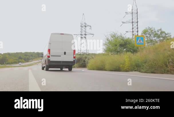 Cargo minibus drives on the highway in sunny weather. White Cargo ...