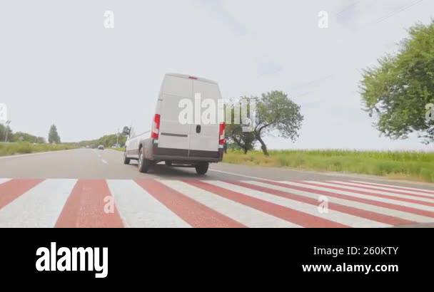 Cargo minibus drives on the highway in sunny weather. White Cargo ...