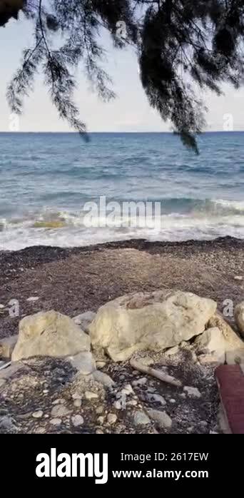 This tranquil setting features a rocky beach with smooth stones and ...