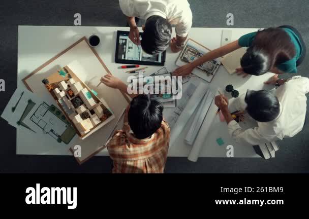 Top down aerial view of architect engineer team writing sticky notes ...