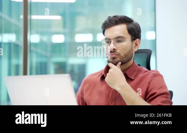 Focused businessman analyzing work on laptop in office, thoughtful ...