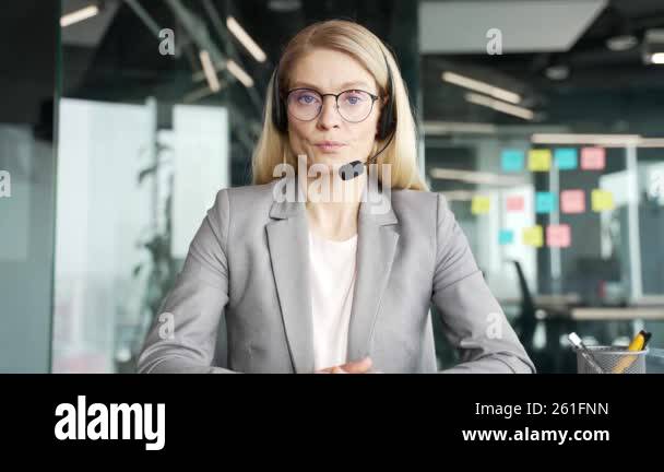 Webcam view. Confident female in wireless headset customer service ...