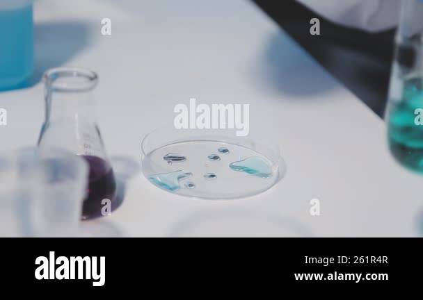 laboratory glass in laboratory with blue liquid Stock Video Footage - Alamy