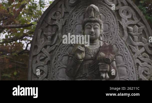 A buddhism stone statue at Japanese temple. High quality 4k footage ...