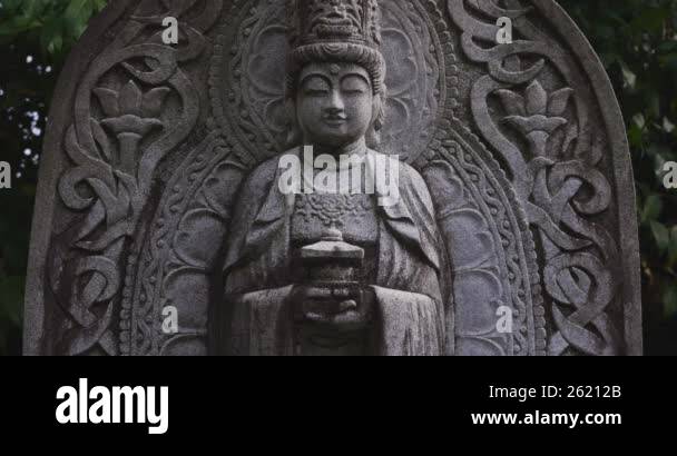 A buddhism stone statue at Japanese temple. High quality 4k footage ...