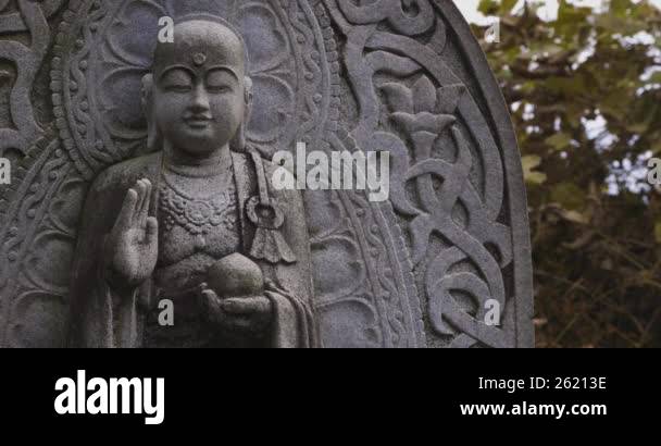 A buddhism stone statue at Japanese temple. High quality 4k footage ...