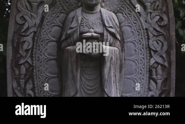 A buddhism stone statue at Japanese temple. High quality 4k footage ...