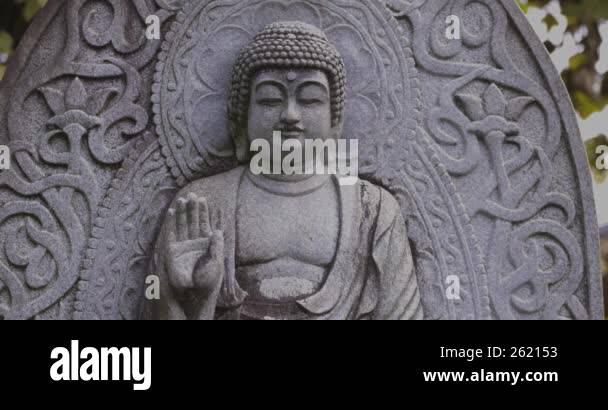 A buddhism stone statue at Japanese temple. High quality 4k footage ...