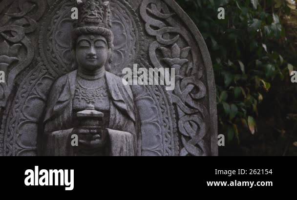 A buddhism stone statue at Japanese temple. High quality 4k footage ...
