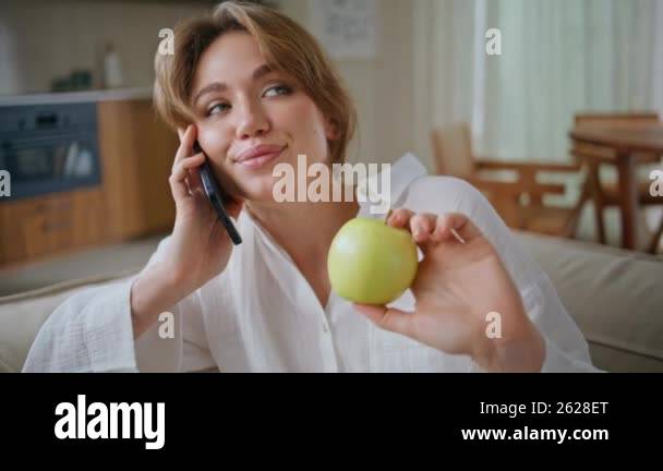 Smiling lady enjoy call on mobile phone relaxing at domestic weekend ...