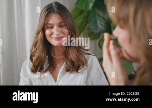Positive girls friends laughing together at relaxed meeting at home ...