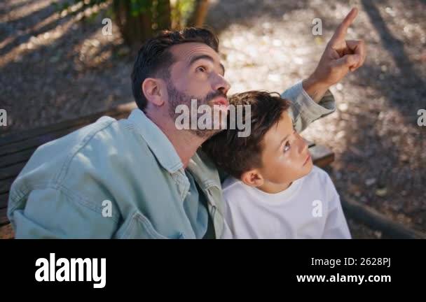 Interested father son looking distance at park weekend closeup. Caring ...
