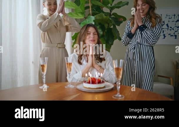 Clapping girls celebrating birthday together at home. Smiling woman ...
