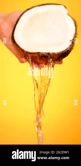 Spilling water from a coconut on a yellow background Stock Video ...