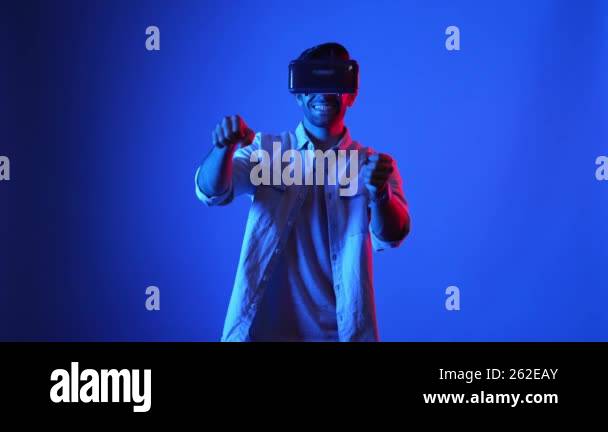 Professional gamer with casual cloth wearing VR goggle while driving ...